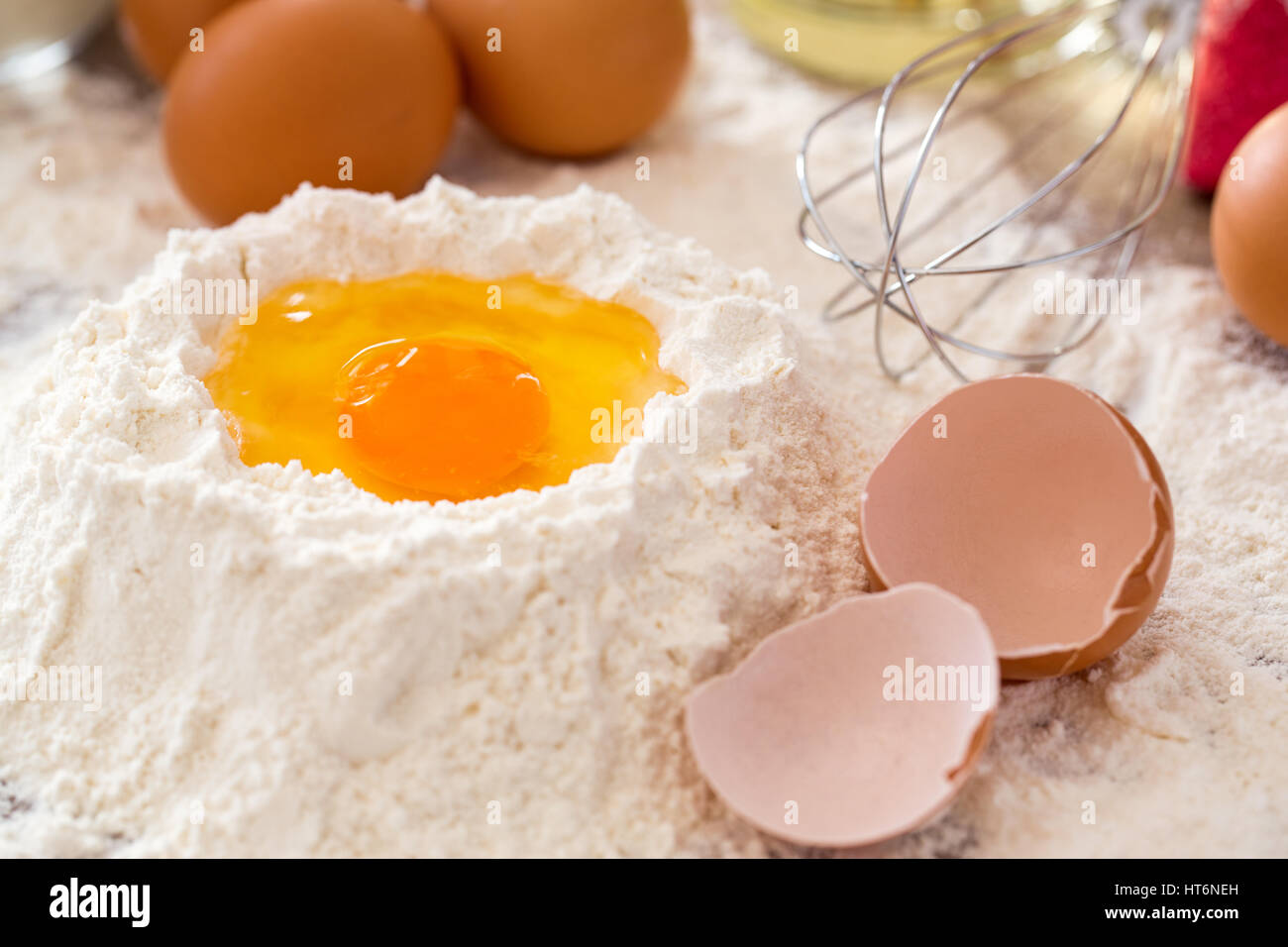Baking ingredients -mixing egg and flour baking cakes background Stock ...