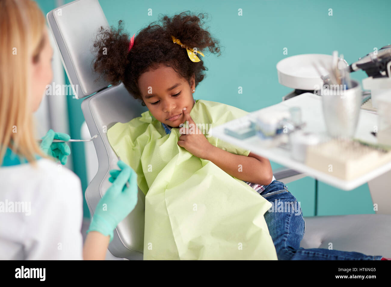 Sad girl with toothache in dental clinic Stock Photo - Alamy