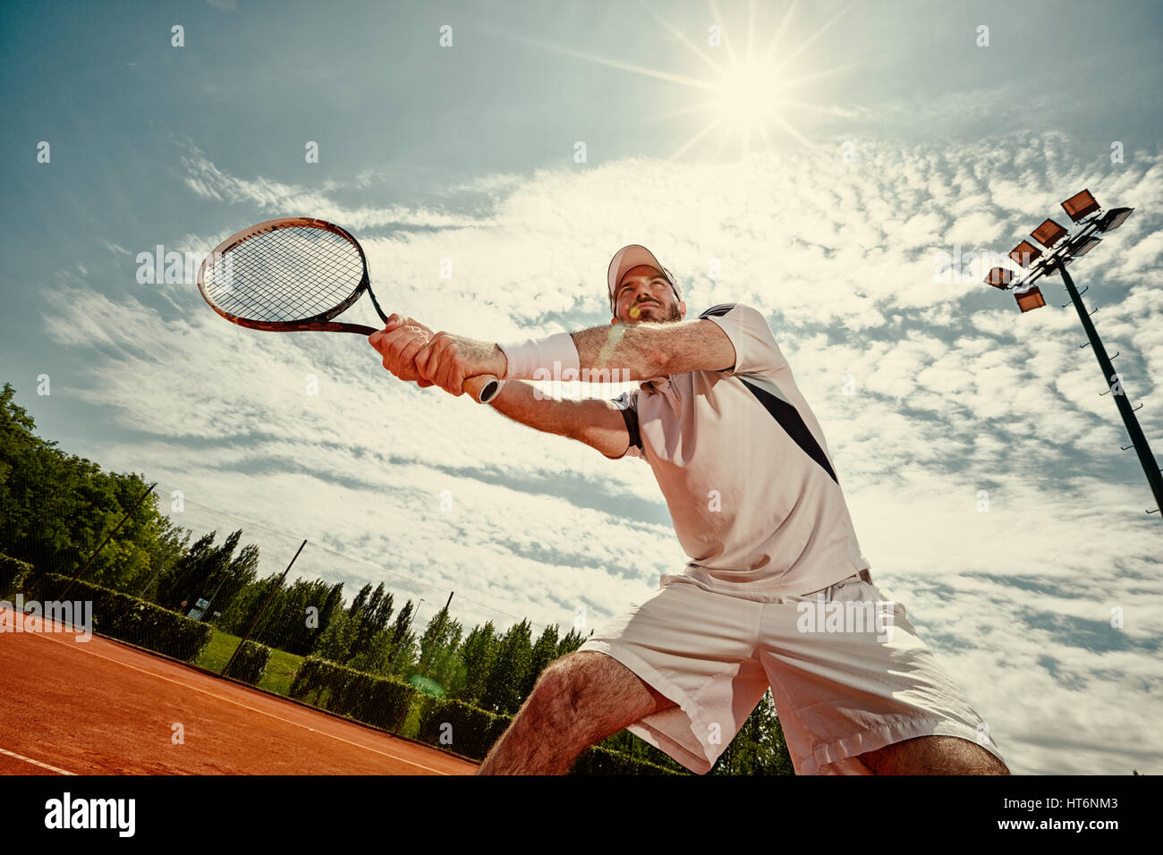Tennis player playing tennis in nature Stock Photo - Alamy