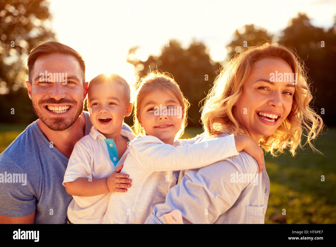 Happy family with male and female children Stock Photo - Alamy