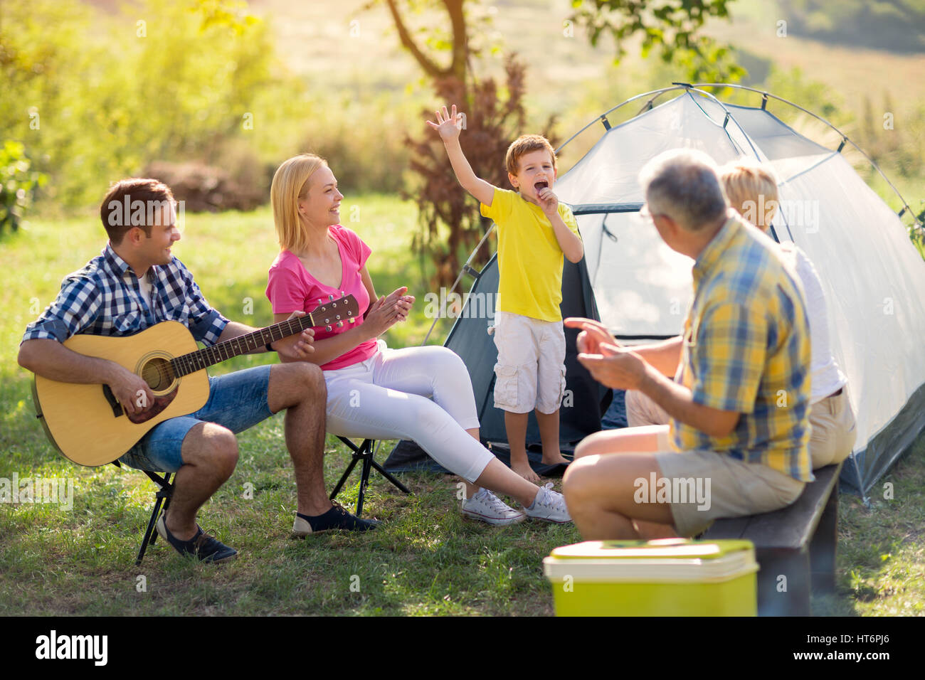 child singing with family on camping Stock Photo - Alamy