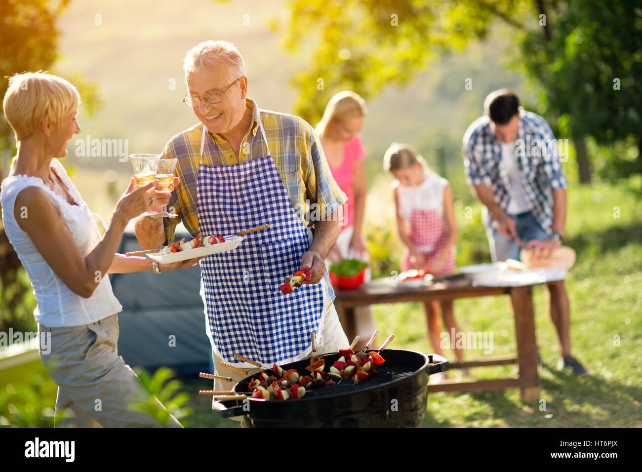 Family vacation having barbecue hi-res stock photography and images - Alamy