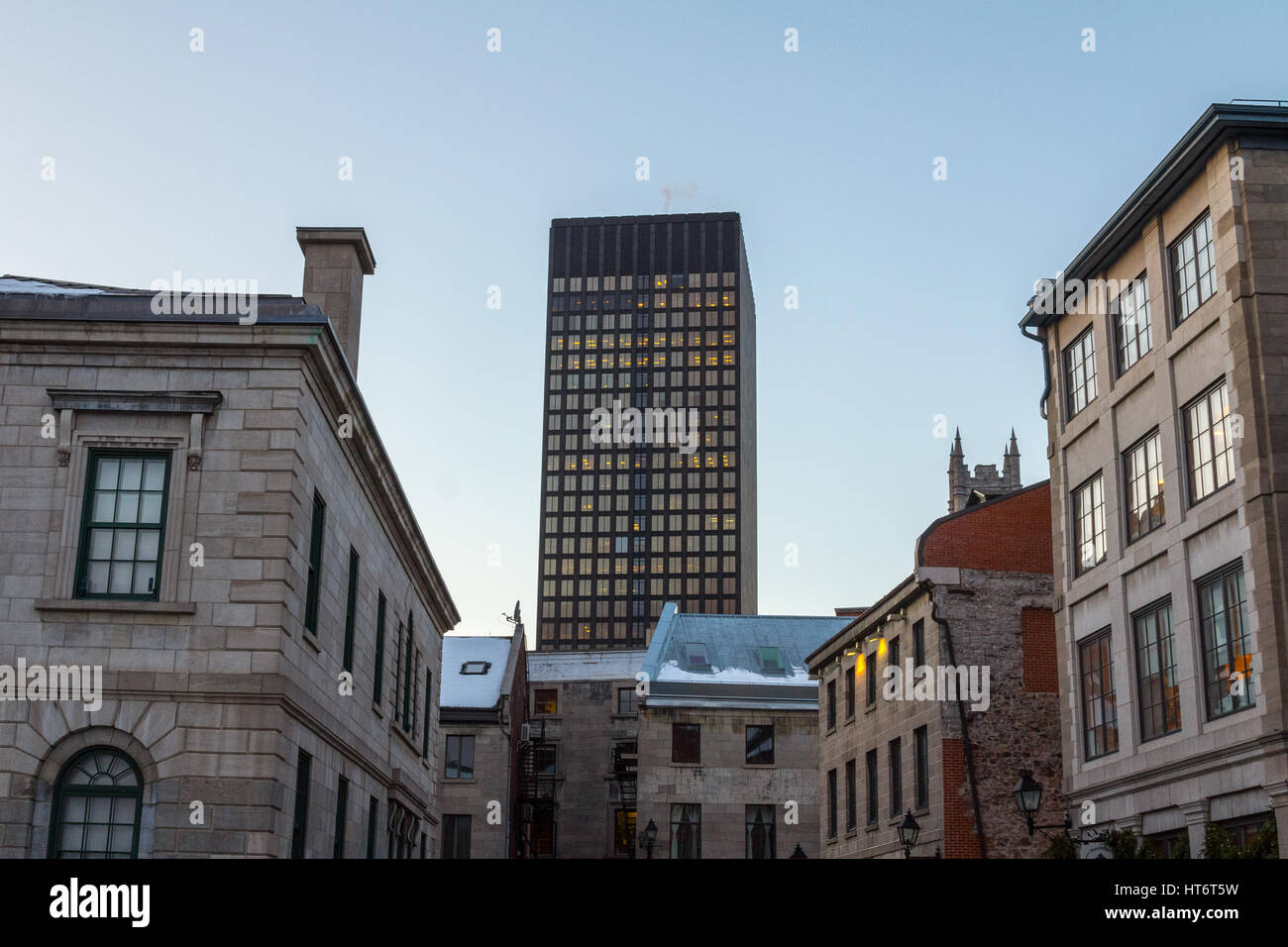 Modern skyscraper next to the older houses of Old Montreal, Quebec ...