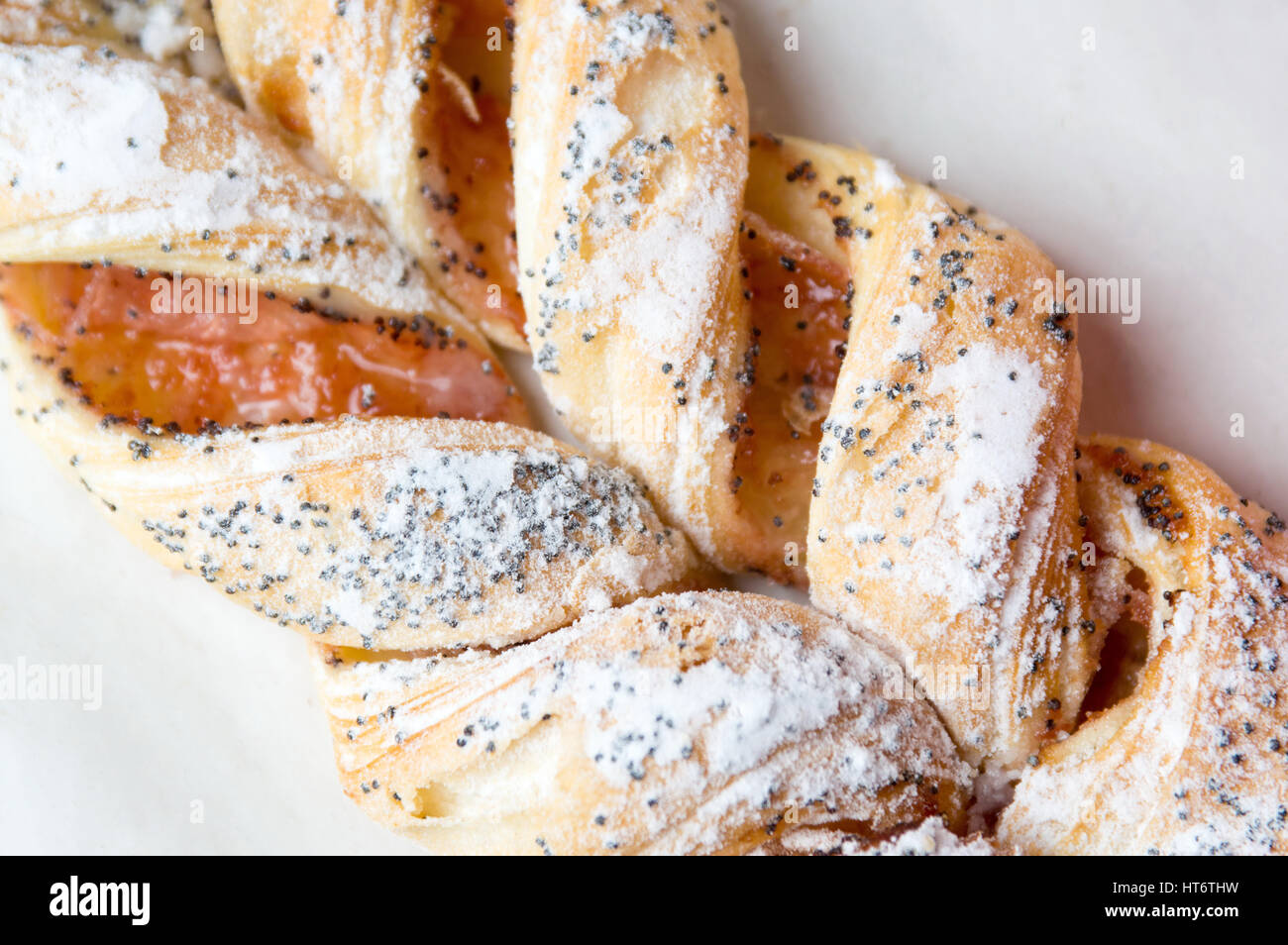 Close up of braided sweet puff pastry with poppy seeds Stock Photo - Alamy