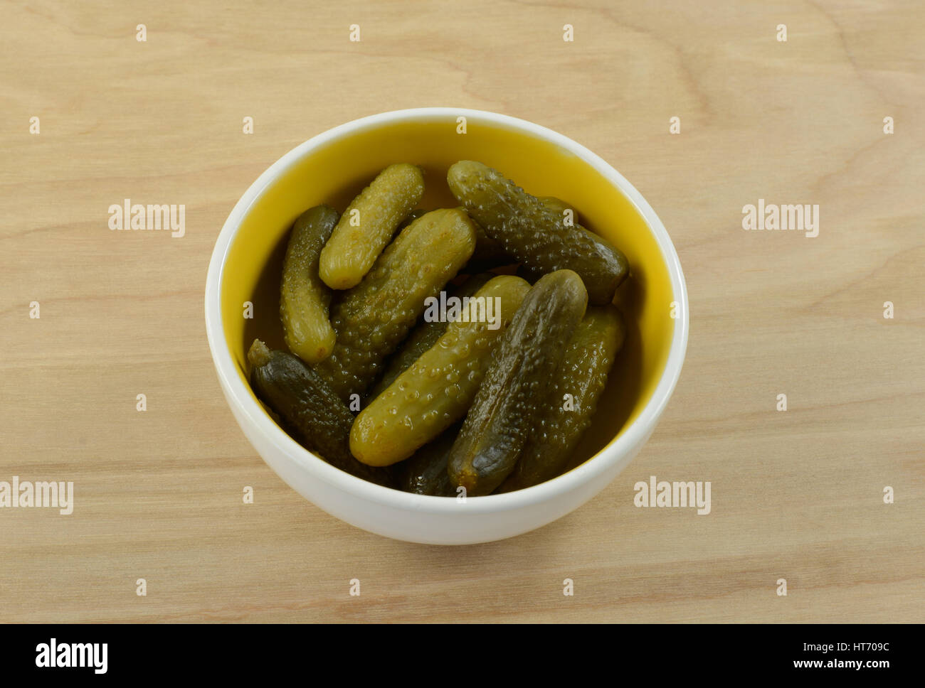 Small sweet gherkin pickles in small condiment bowl Stock Photo - Alamy