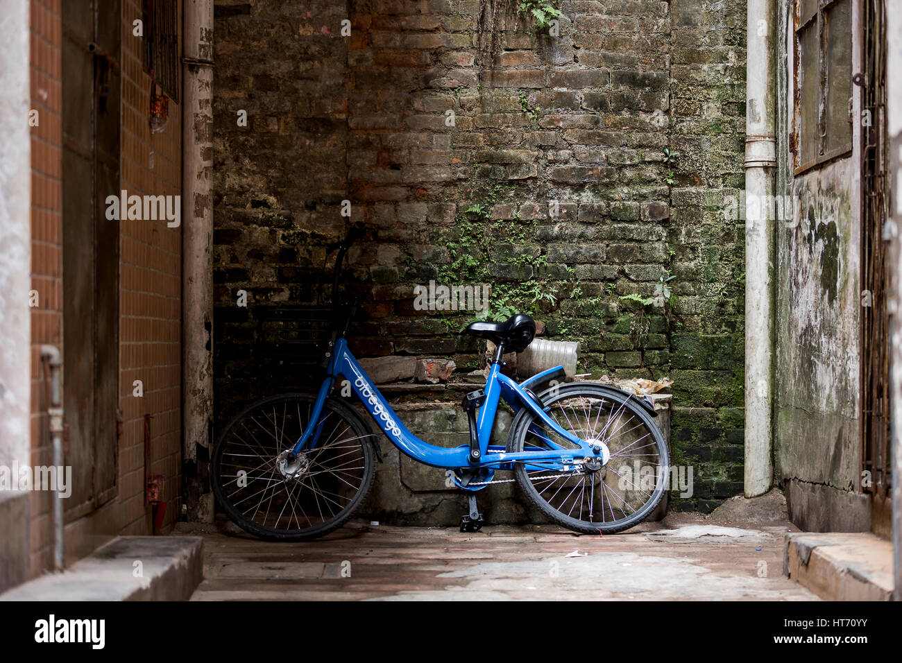 Guangzhou, China. March 2017. Blue city bike parked in an alley way in ...