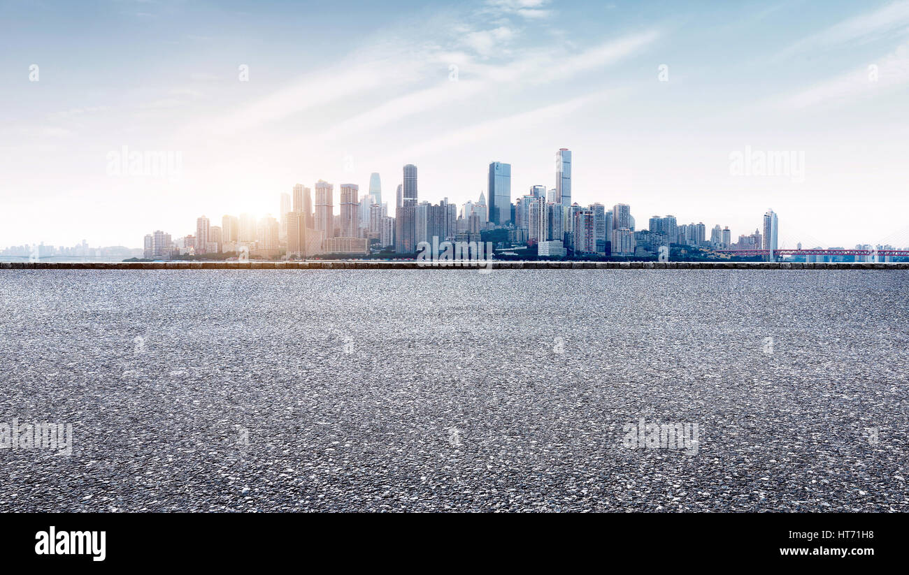 Asphalt road in front of city skyline Stock Photo - Alamy