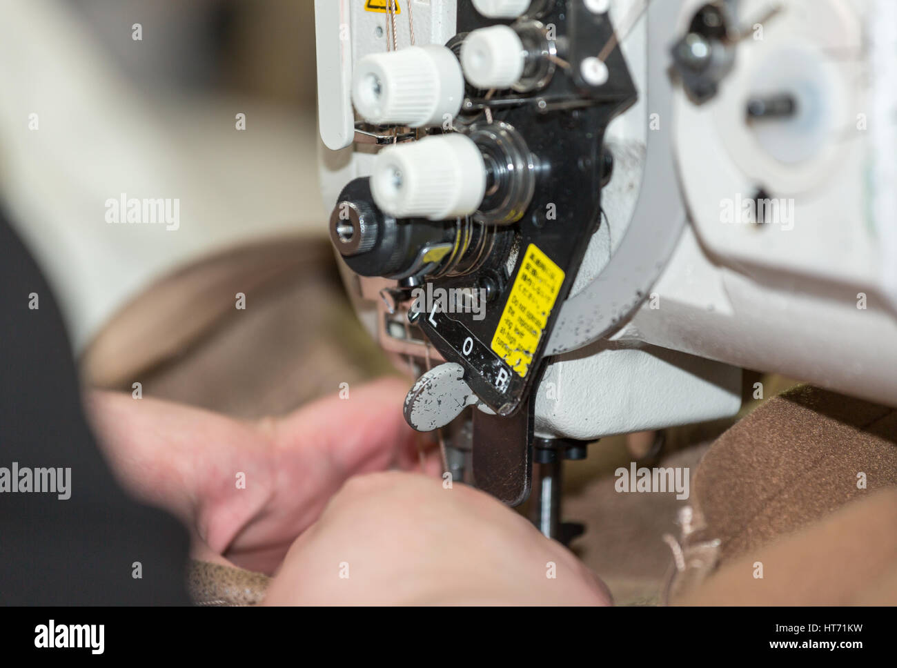 Hands of woman who work on sewing machine with textile Stock Photo - Alamy