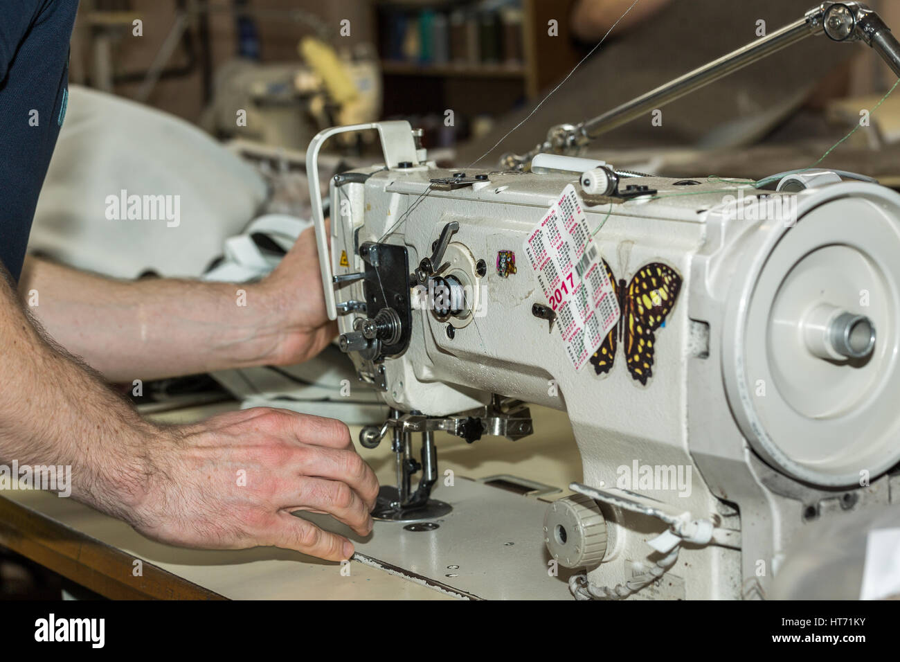 Hands of man who repairs sewing machine Stock Photo - Alamy