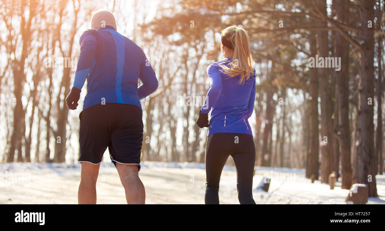 Couple running in nature, back view Stock Photo - Alamy