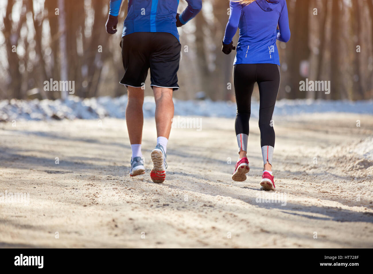 Runners legs while running in nature, back view Stock Photo - Alamy