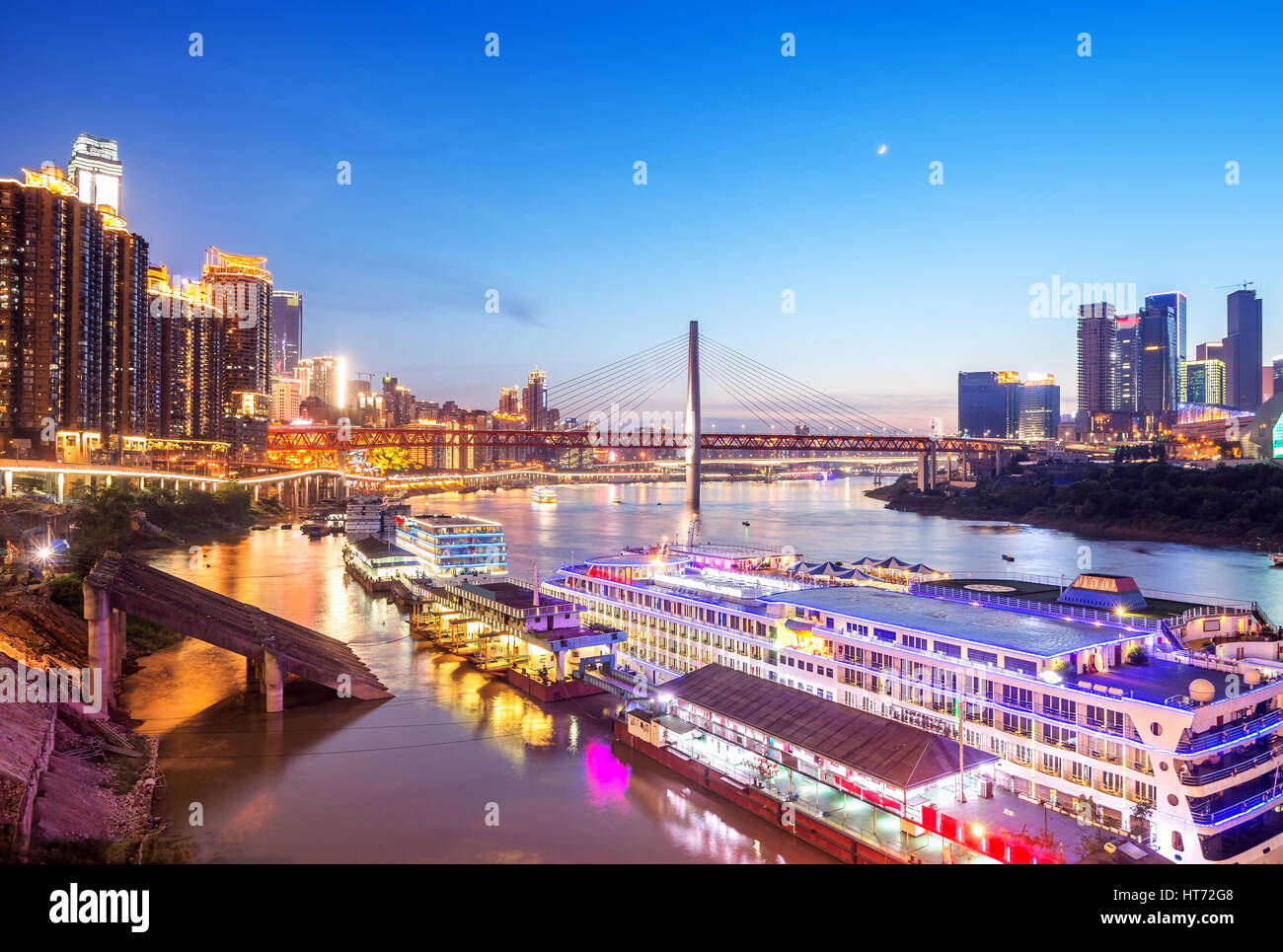 cityscape and skyline of downtown near water of chongqing at night ...