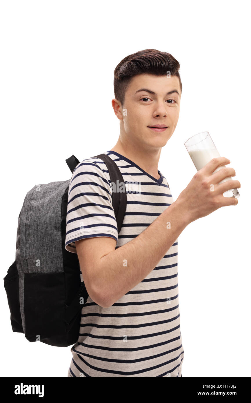 Teenage student drinking a glass of milk isolated on white background ...