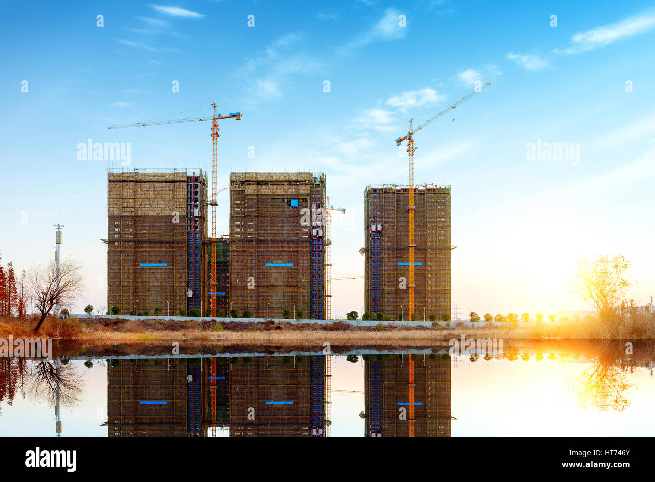 Riverfront construction site and reflection, dusk landscape Stock Photo ...