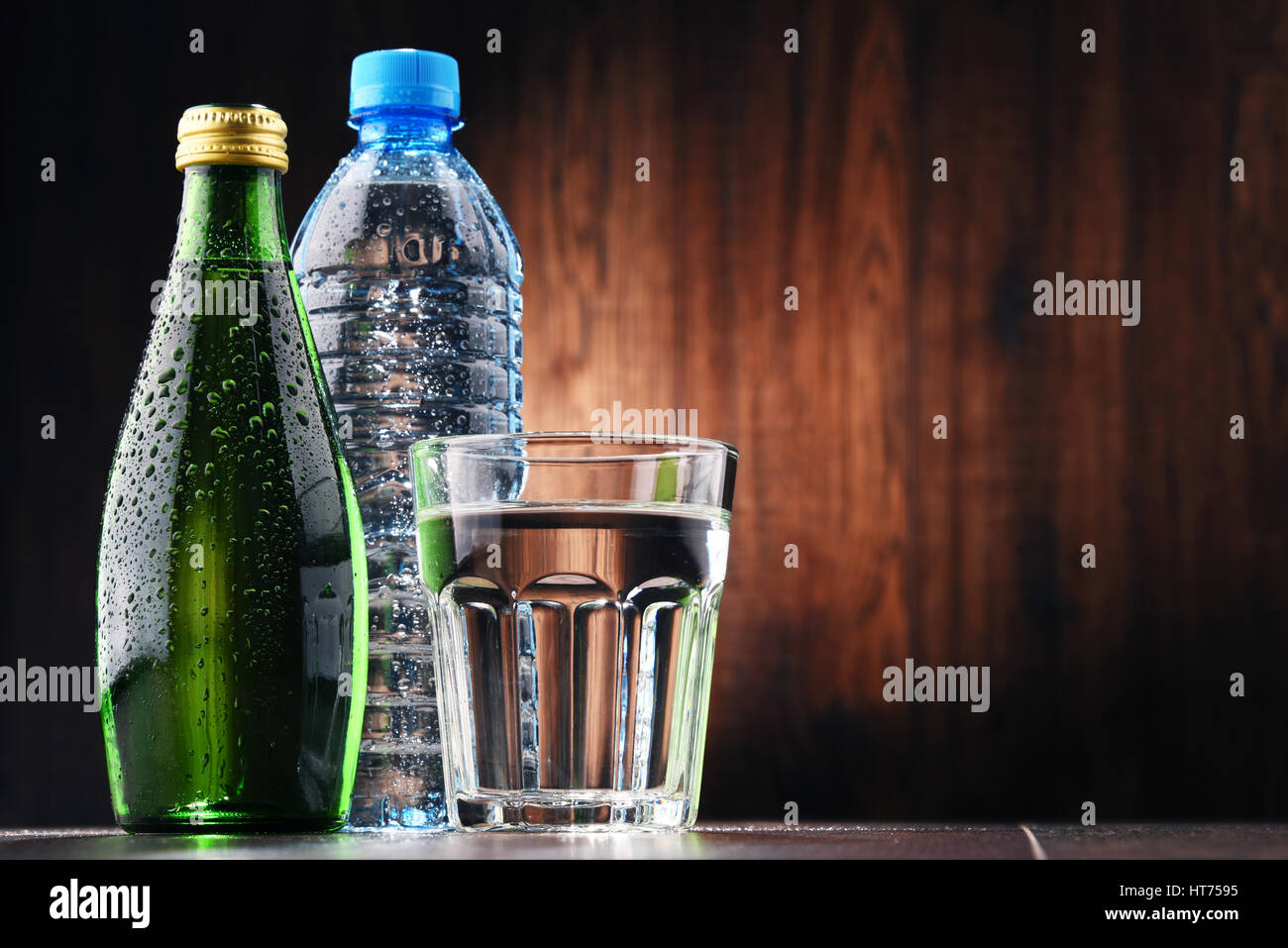 Composition with glass and bottles of mineral water Stock Photo - Alamy