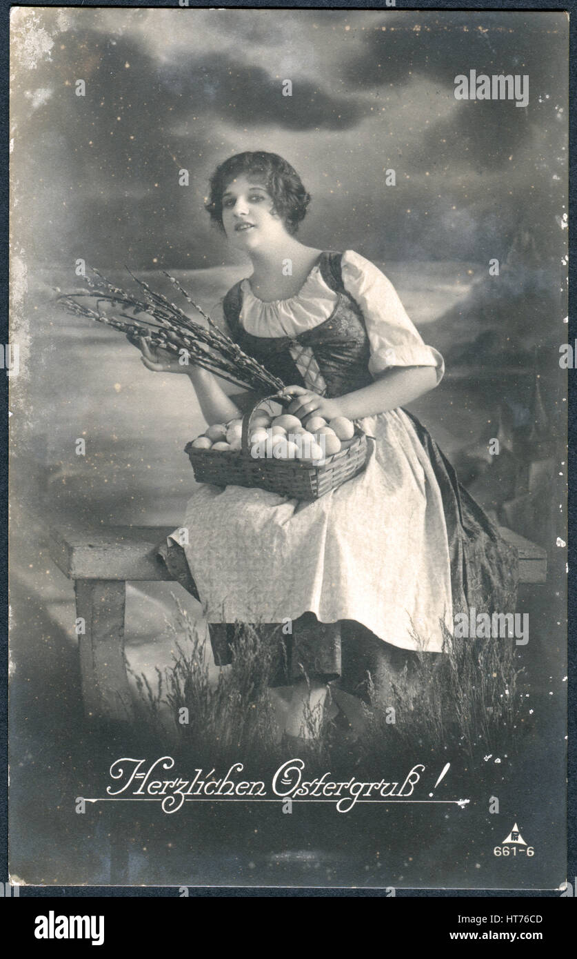 A postcard printed in Germany, shows a rural landscape, a girl with a ...