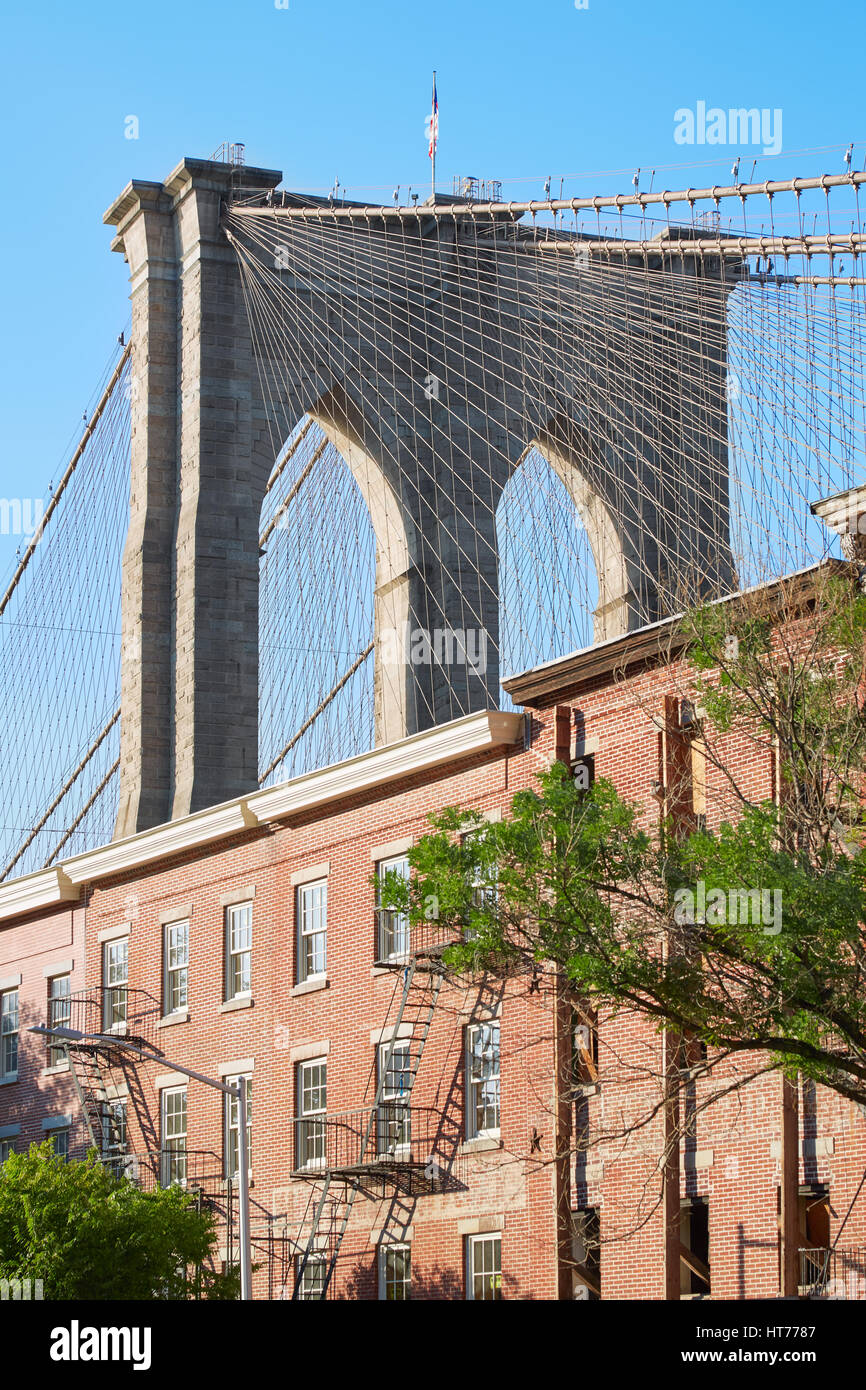 Brooklyn Bridge pillar and New York red bricks facades in afternoon ...