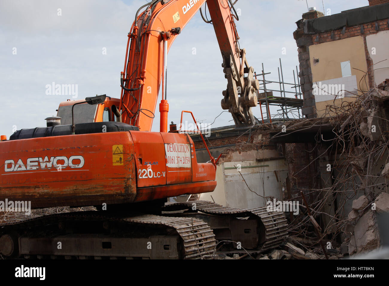 Heavy machinery at work on a demolition site. Tearing down old shops ...
