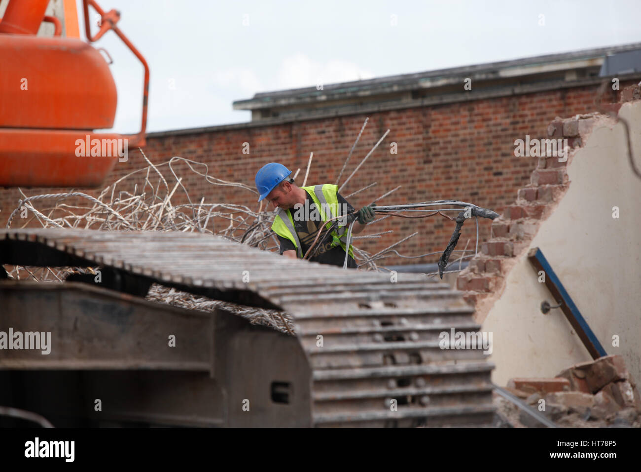 Demolition worker sorting copper pipe from debris Stock Photo - Alamy