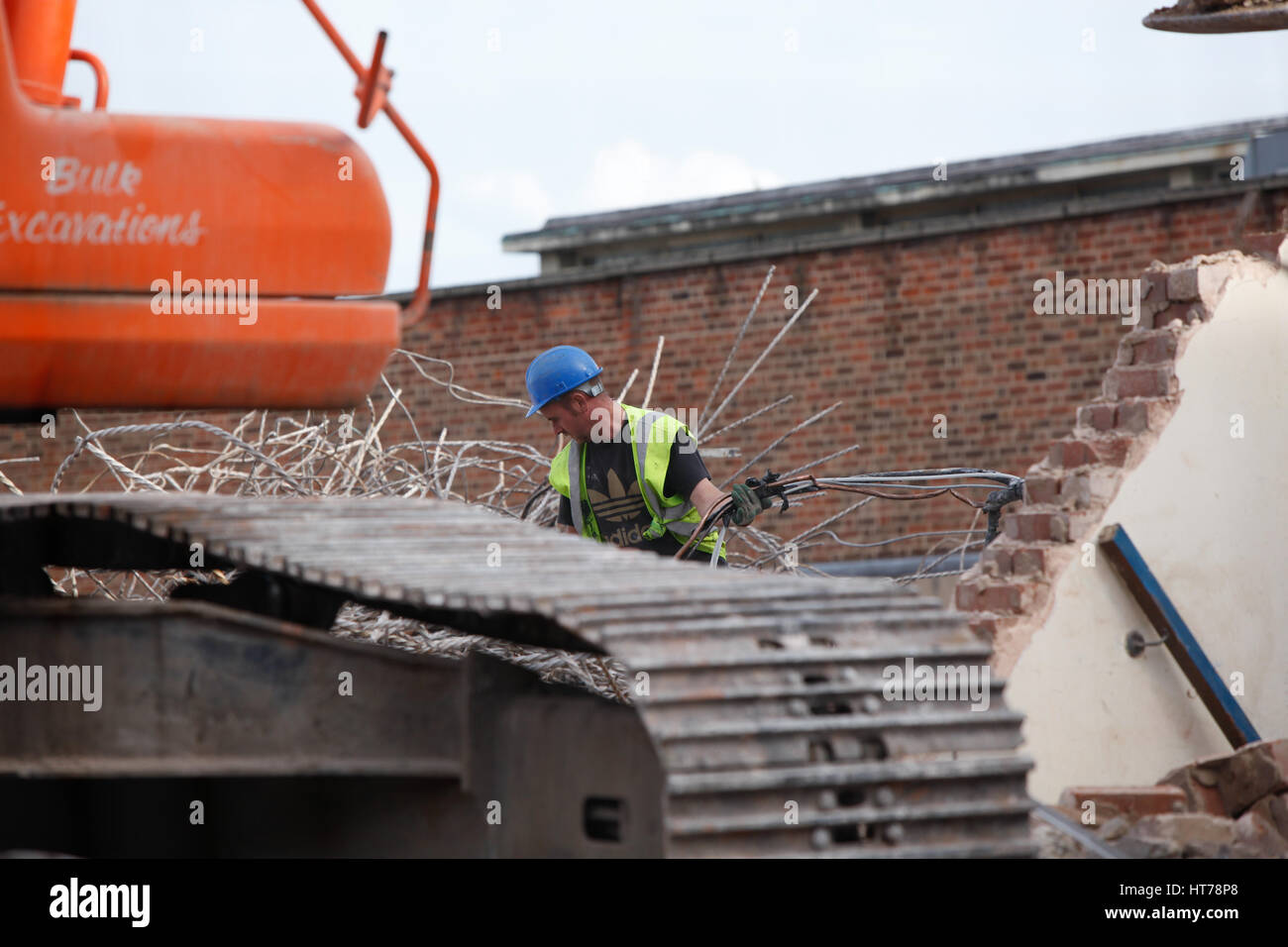 Demolition worker sorting copper pipe from debris Stock Photo - Alamy