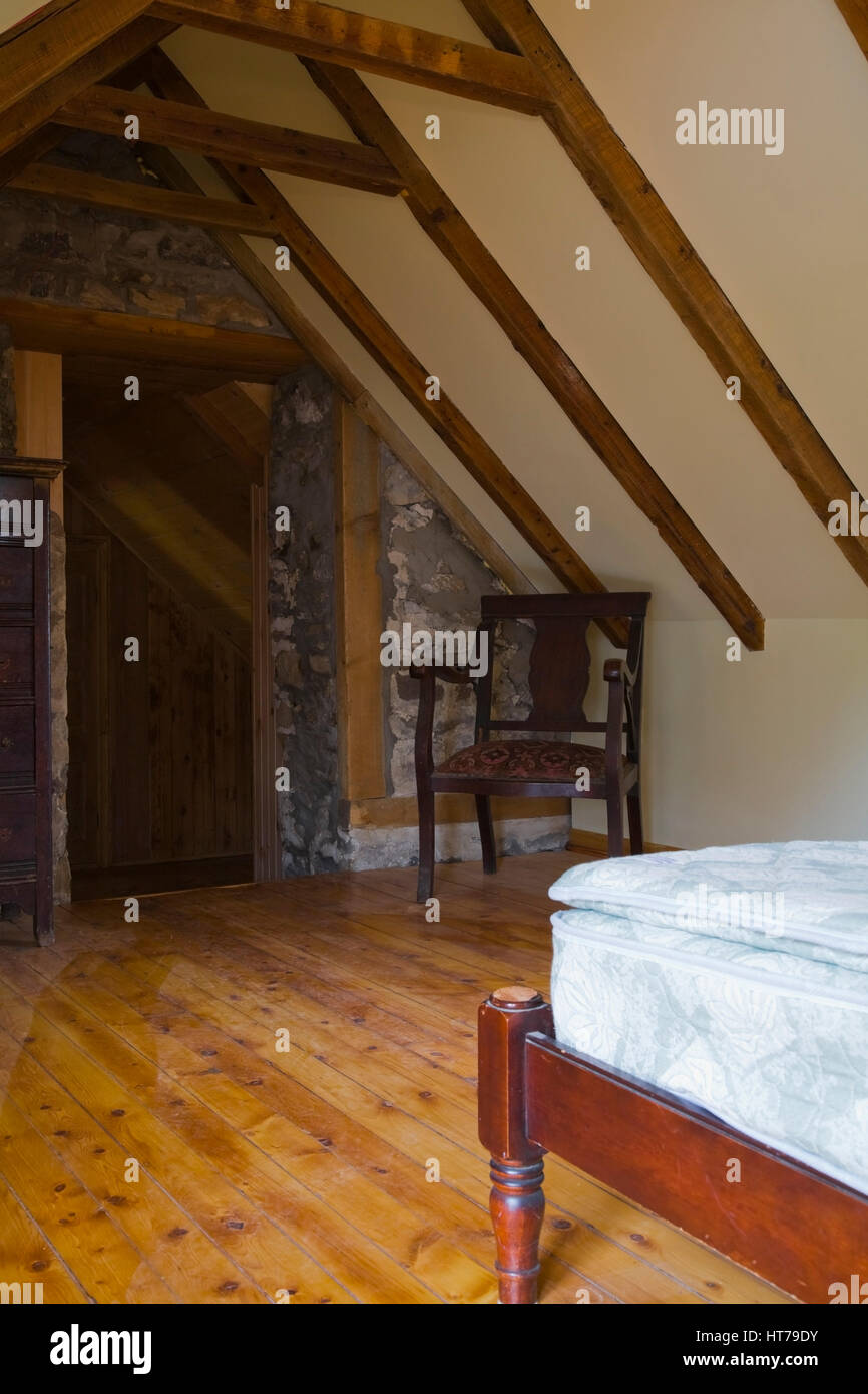 Master bedroom with sparse furnishings in 1826 Canadiana fieldstone old ...