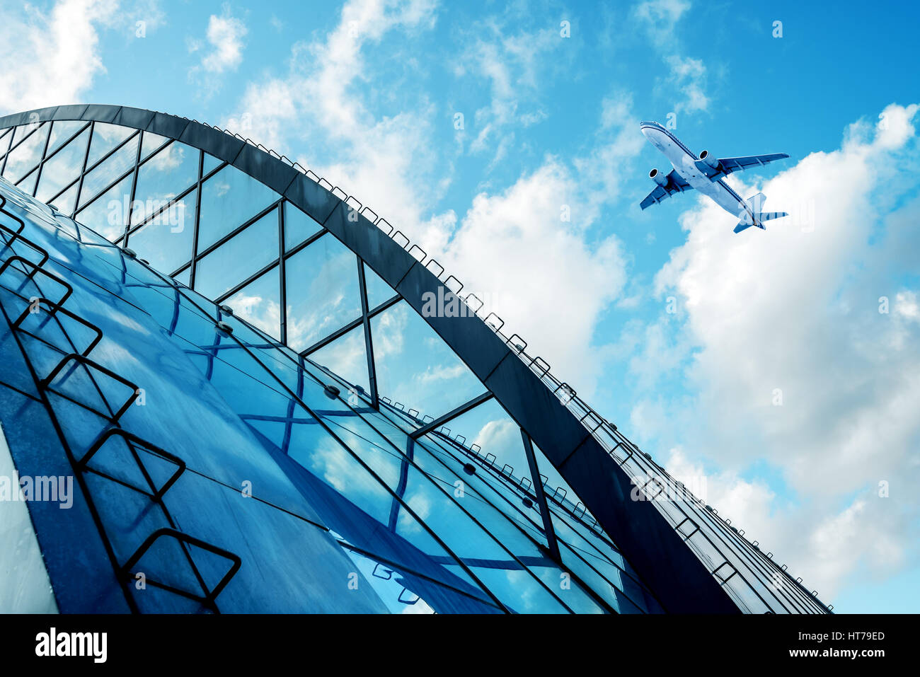 Shot of airplane flying above glass office buildings. Fisheye lens ...
