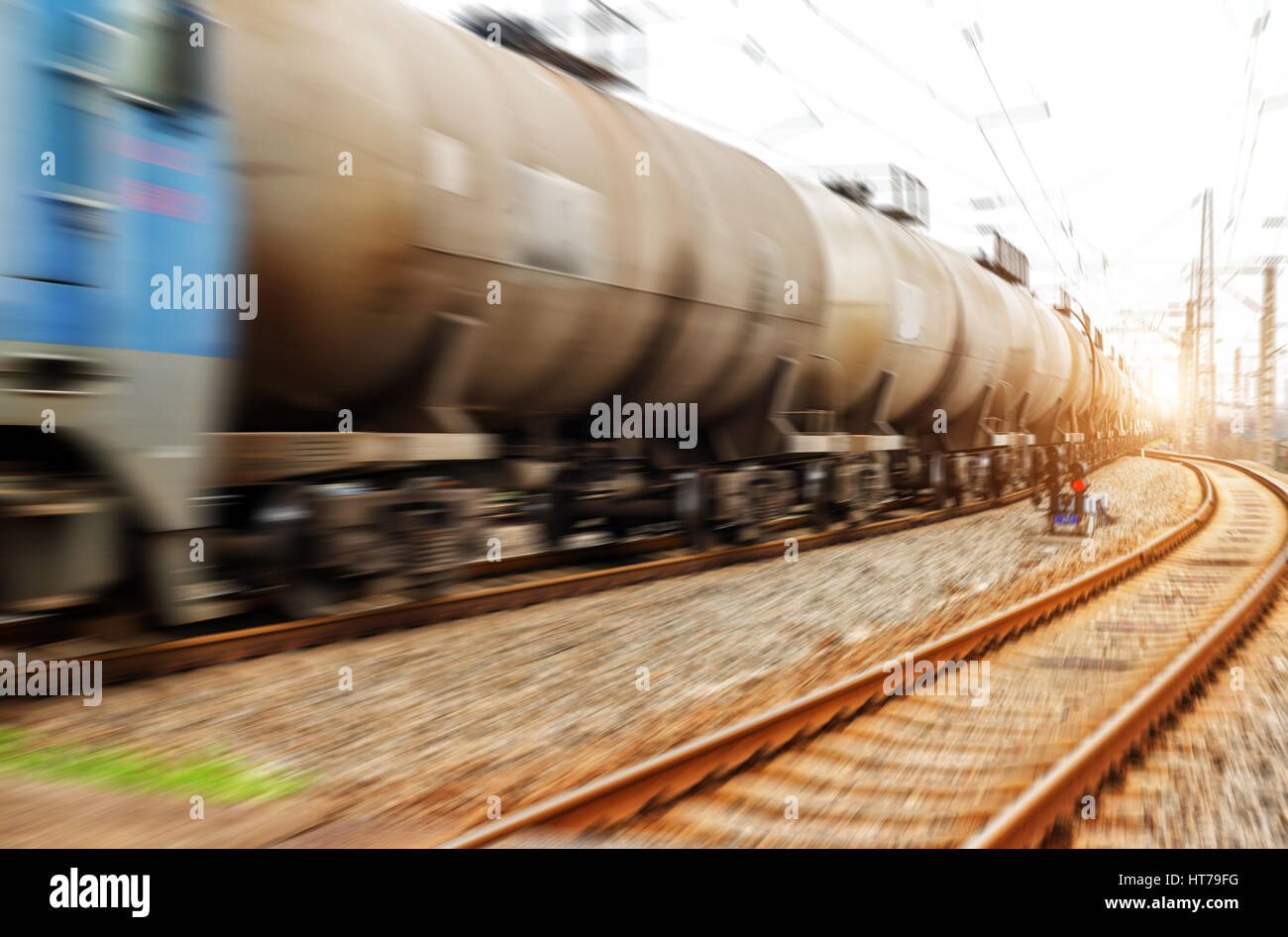 Railroad train of tanker cars transporting crude oil on the tracks ...