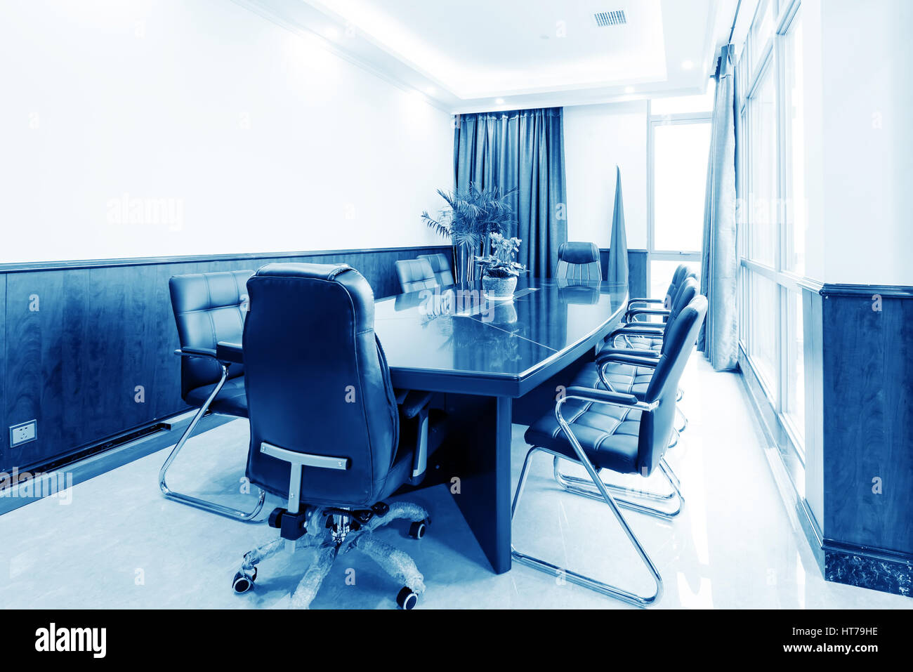 Conference room with large table and chairs, blue tones Stock Photo - Alamy