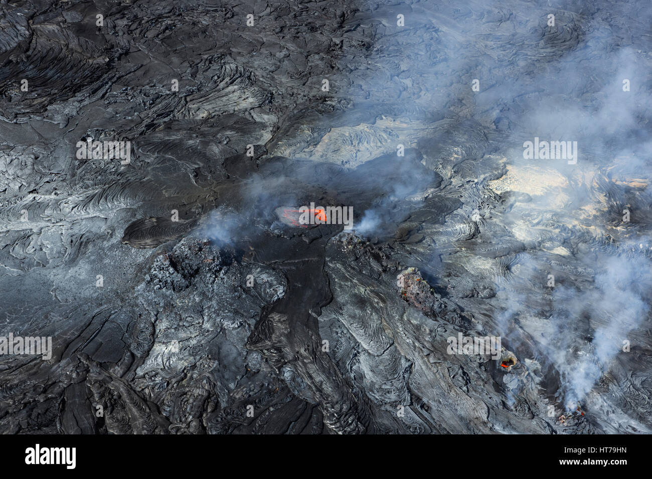 Aerial view of Volcanoes NP, Puʻu ʻŌʻō, lava skylight in lava field ...