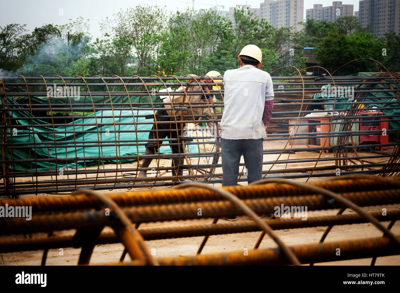 welder worker welding metal by electrode with bright electric arc and ...