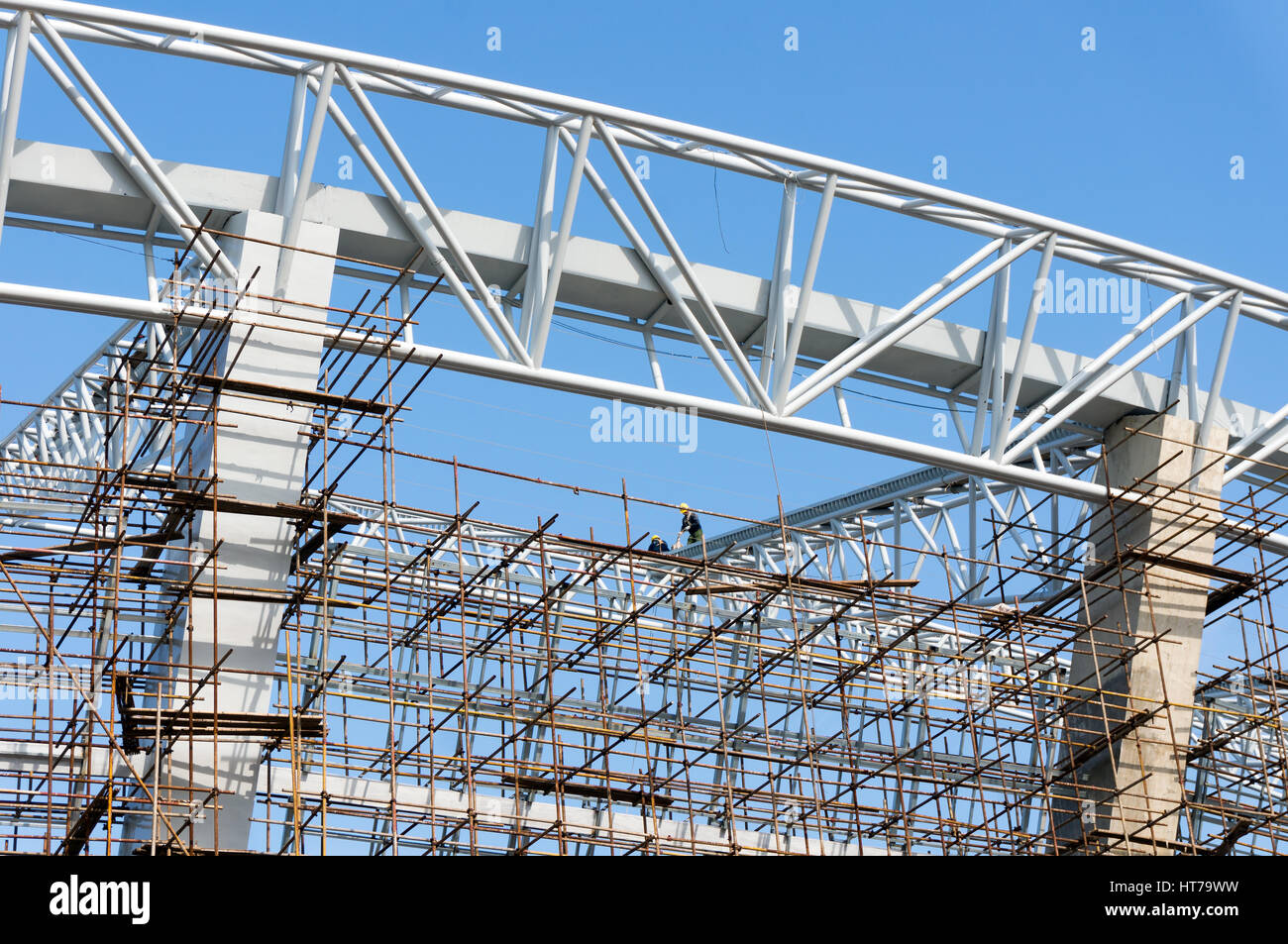 Construction workers working on scaffolding, construction site steel ...