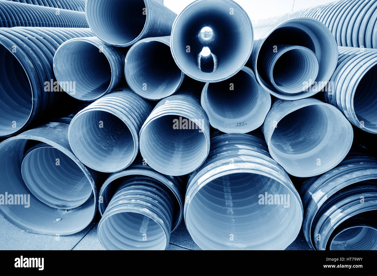 background of colorful big plastic pipes used at the building site ...