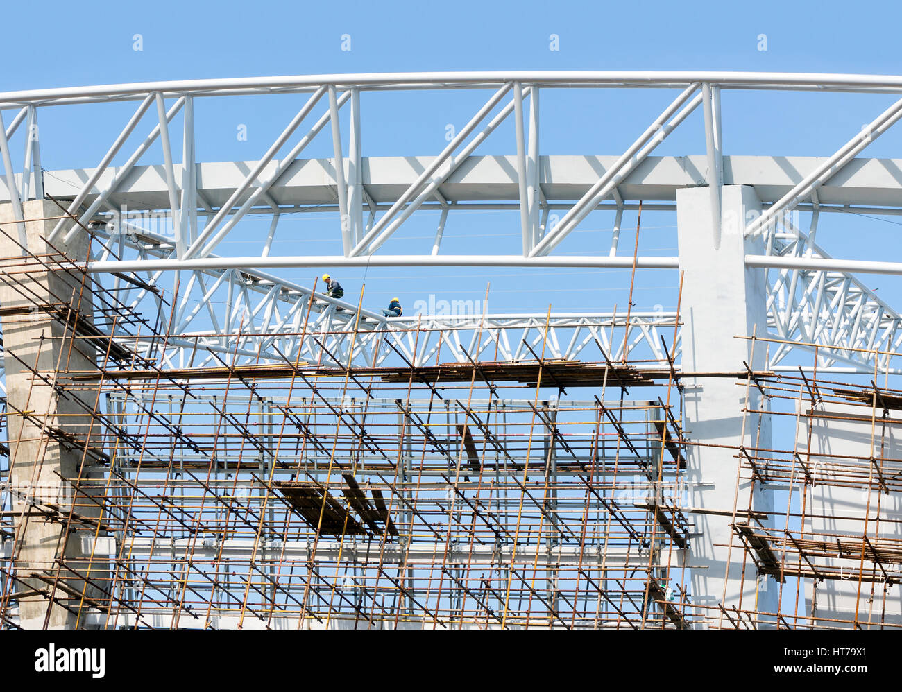 Construction workers working on scaffolding, construction site steel ...