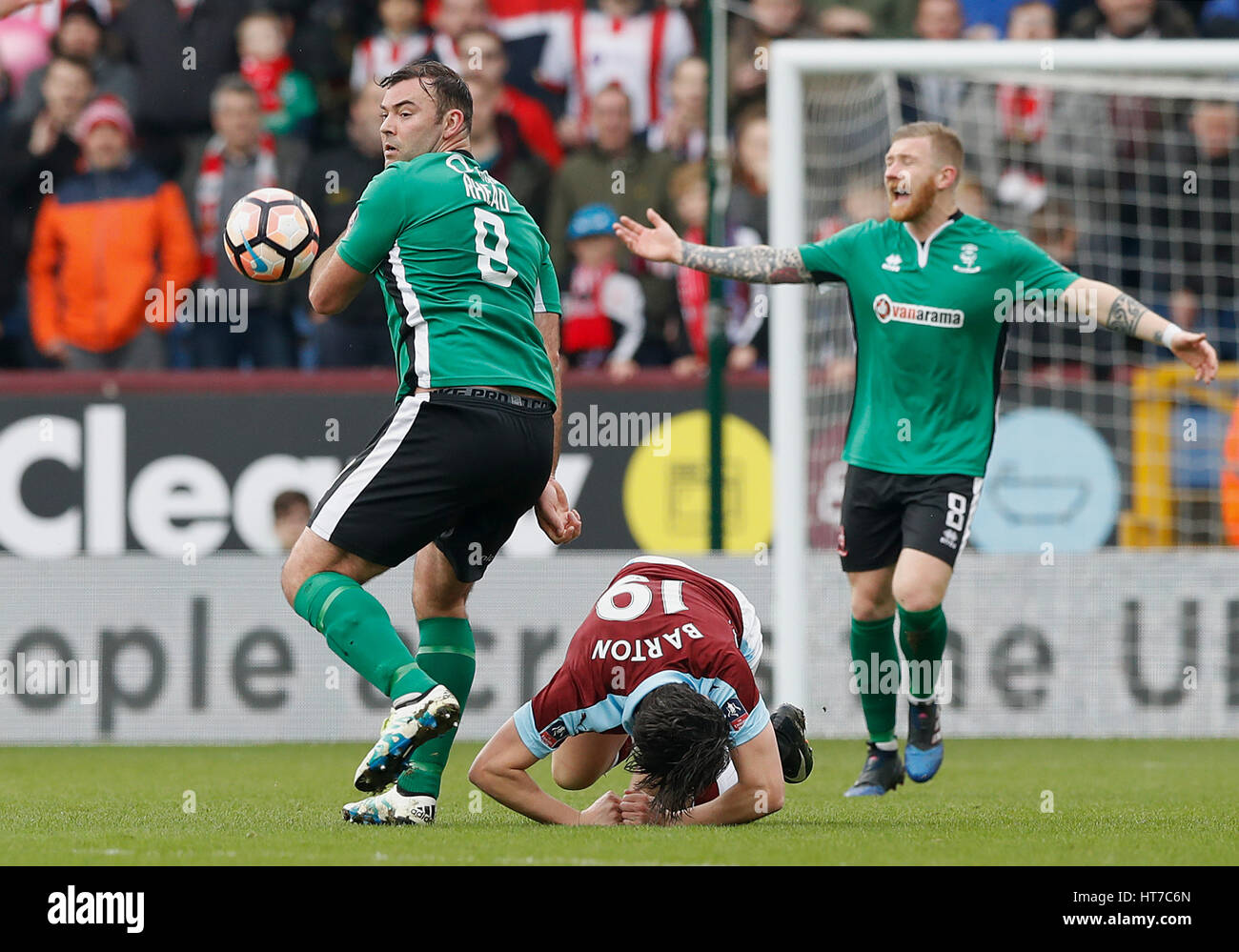 Lincoln City's Matt Rhead (left) clashes with Burnley's Joey Barton ...