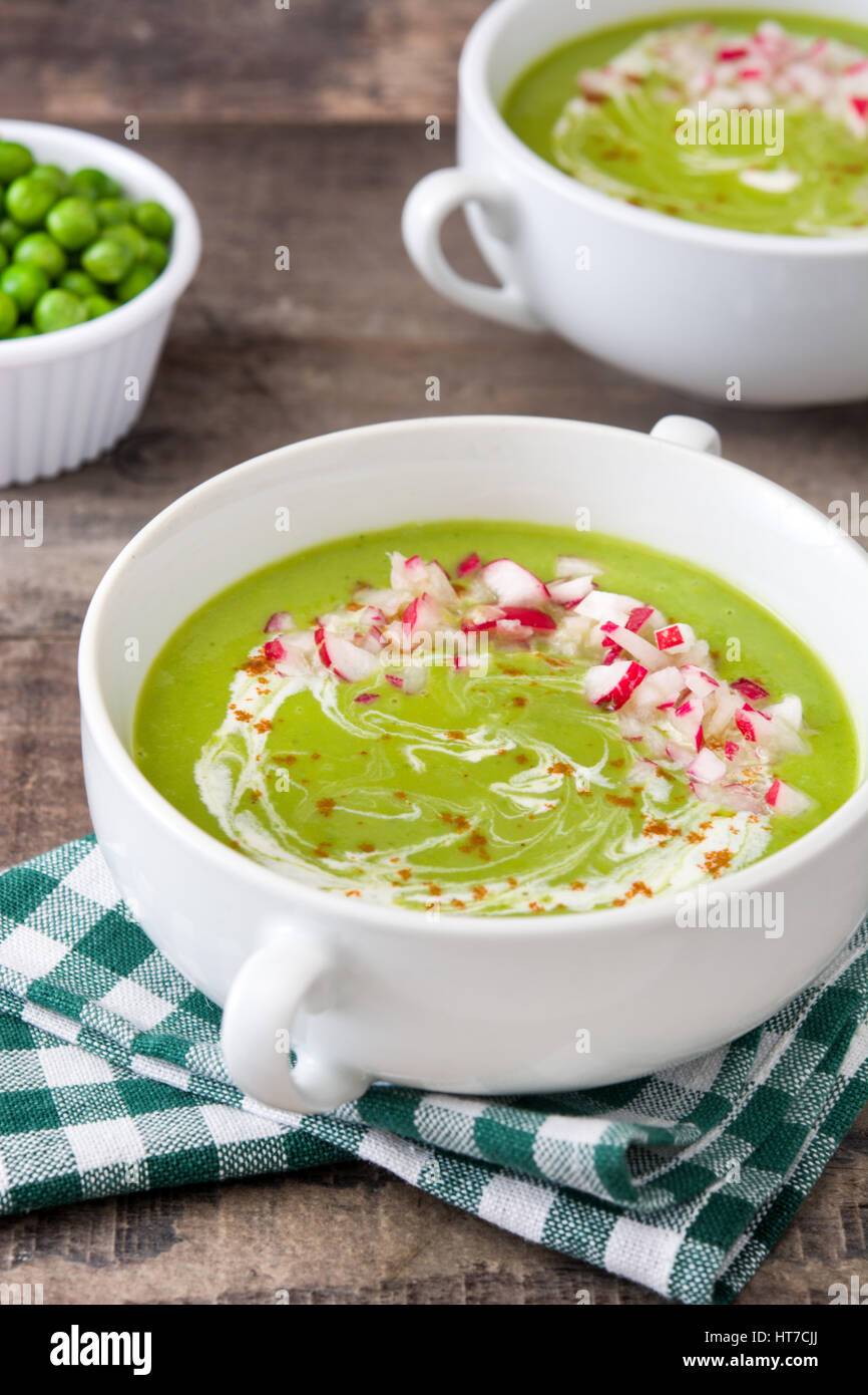 Peas cream with radishes on rustic wooden table Stock Photo - Alamy