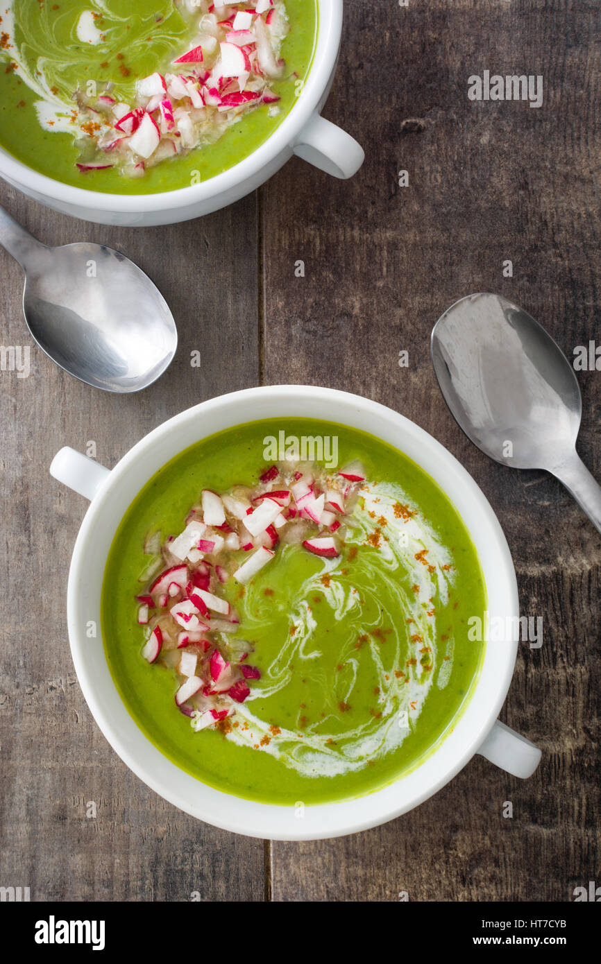 Peas cream with radishes on rustic wooden table Stock Photo - Alamy