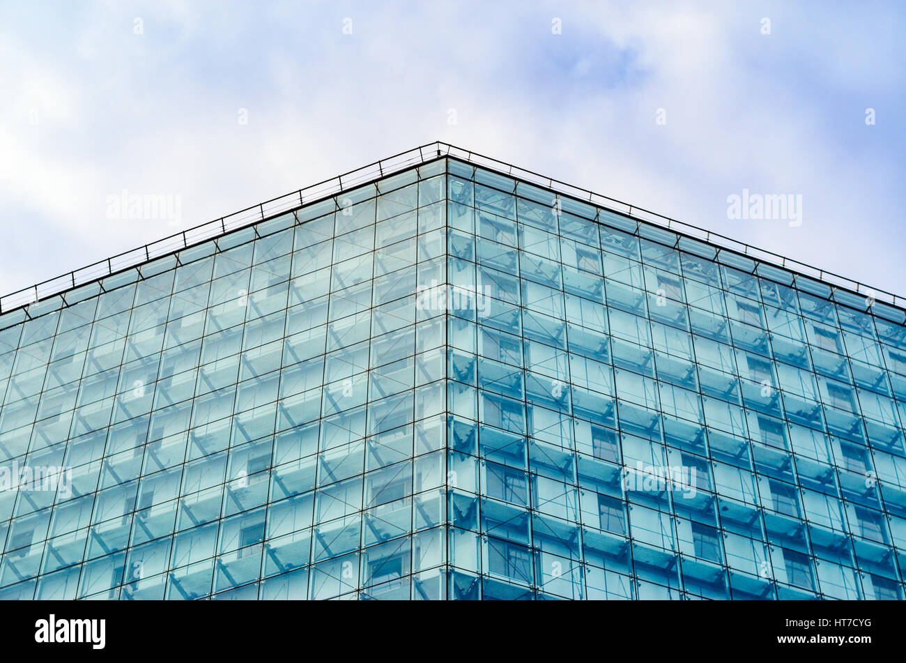 Modern glossy facade of building against of the cloudy sky. Multilayer ...
