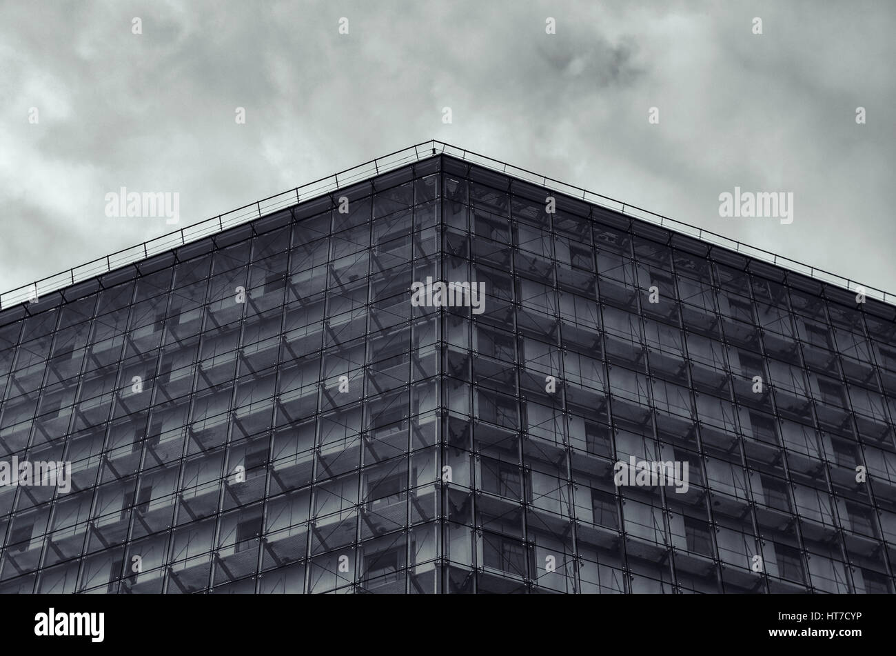 Modern glossy facade of building against of the cloudy sky. Multilayer ...