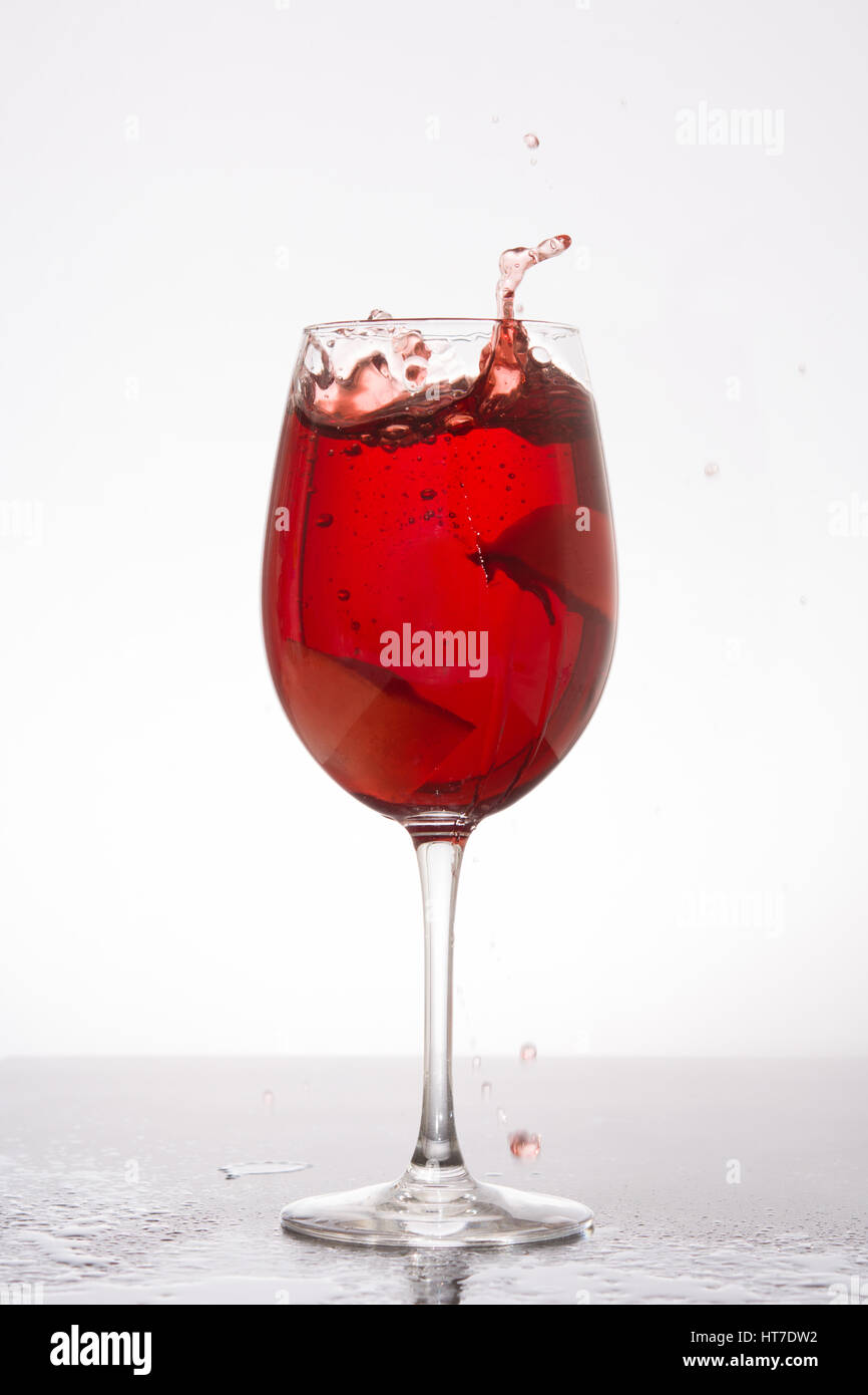 Splash of fresh red drink in cup on white background Stock Photo - Alamy