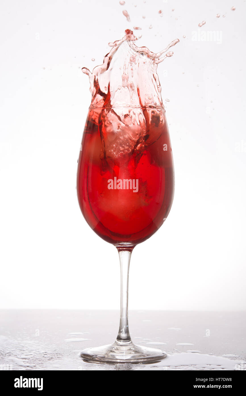 Splash of fresh red drink in cup on white background Stock Photo - Alamy
