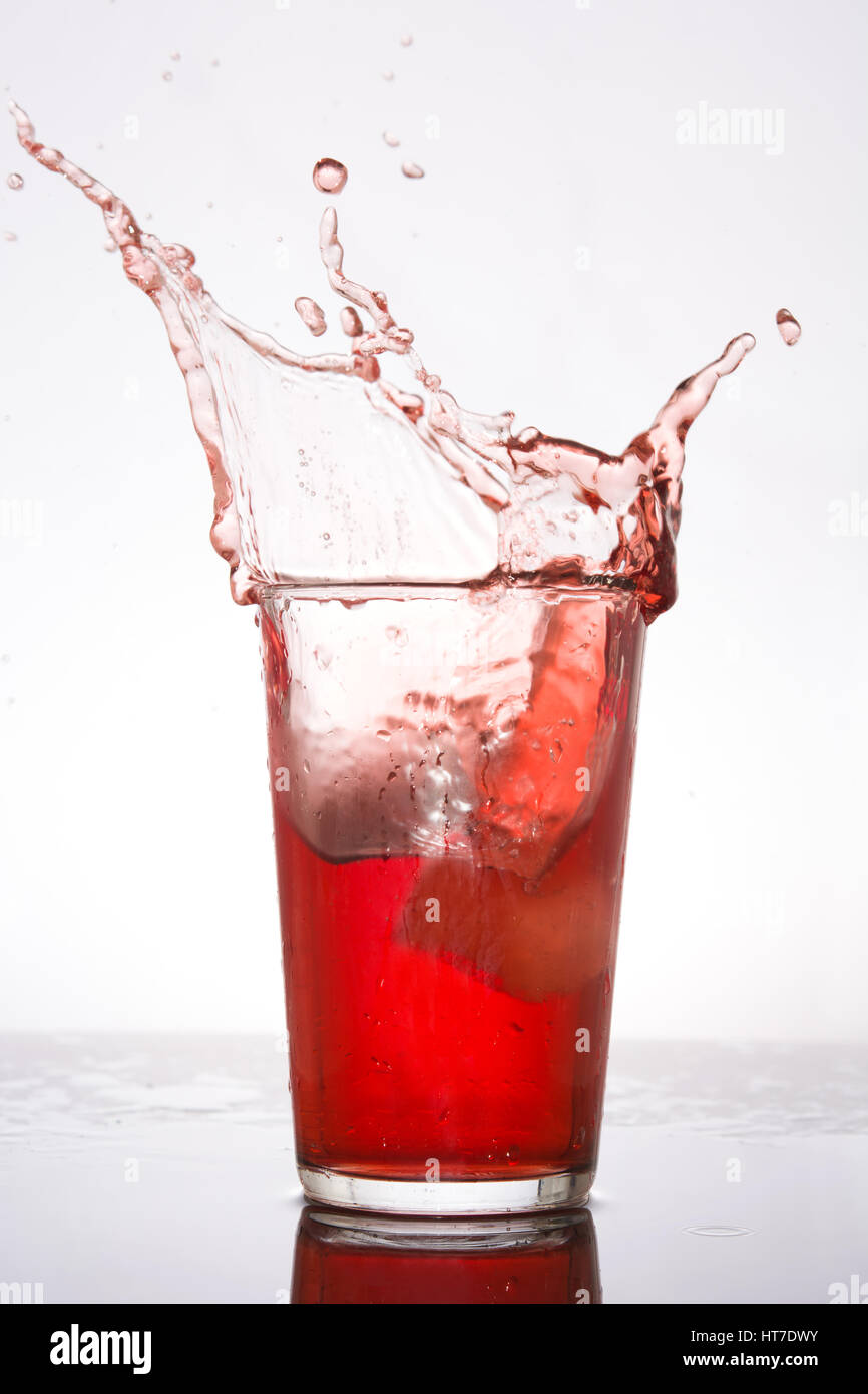 Splash of fresh red drink on white background Stock Photo - Alamy