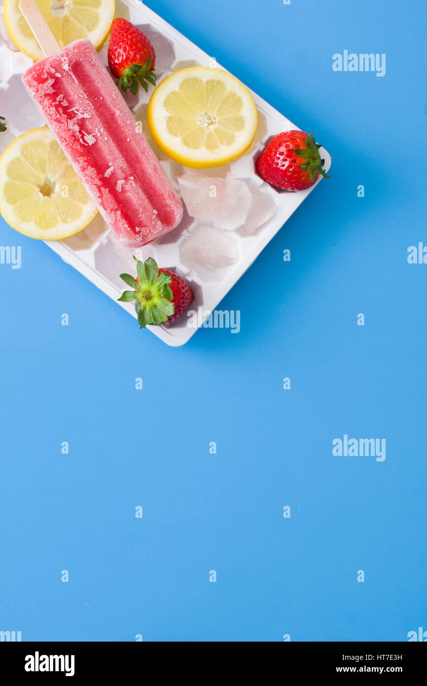 Strawberry popsicle. Blue background Stock Photo - Alamy