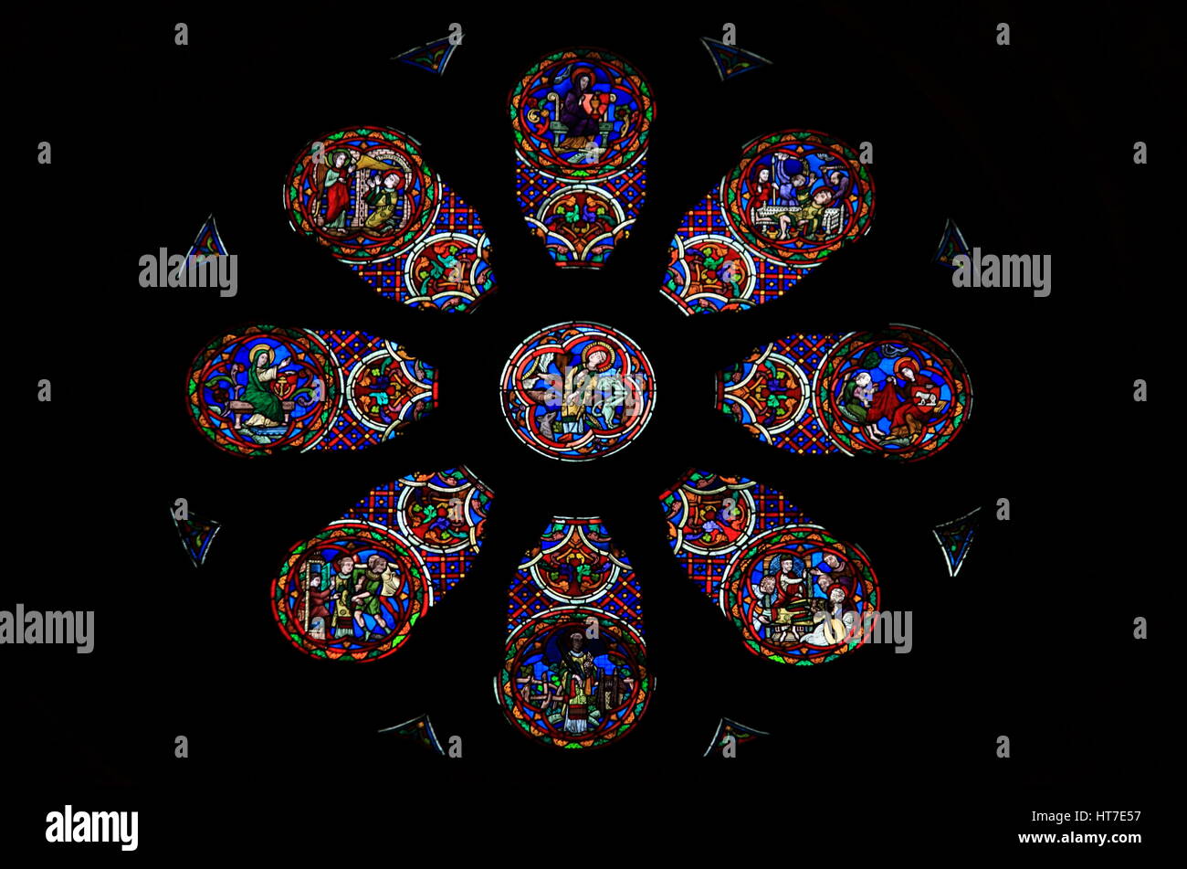 Stained glass rose window with catholic scenes Stock Photo - Alamy