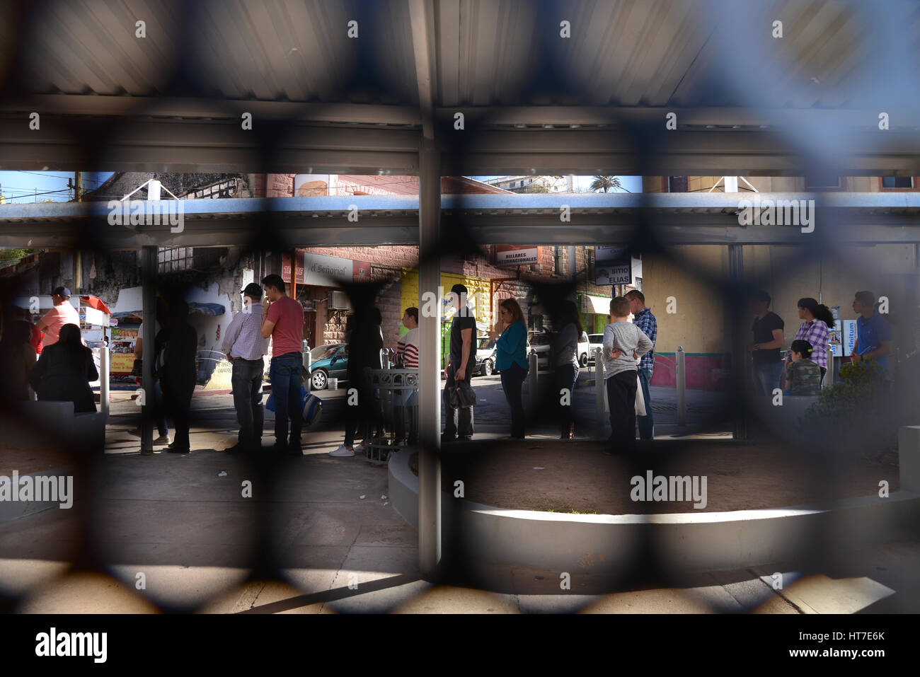 People in Nogales, Sonora, Mexico, wait to cross in to Nogales, Arizona ...