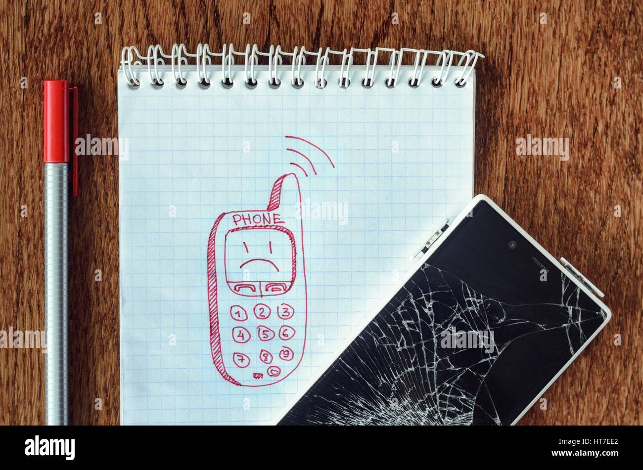 Freehand drawing of old phone in notebook. Smartphone with broken ...