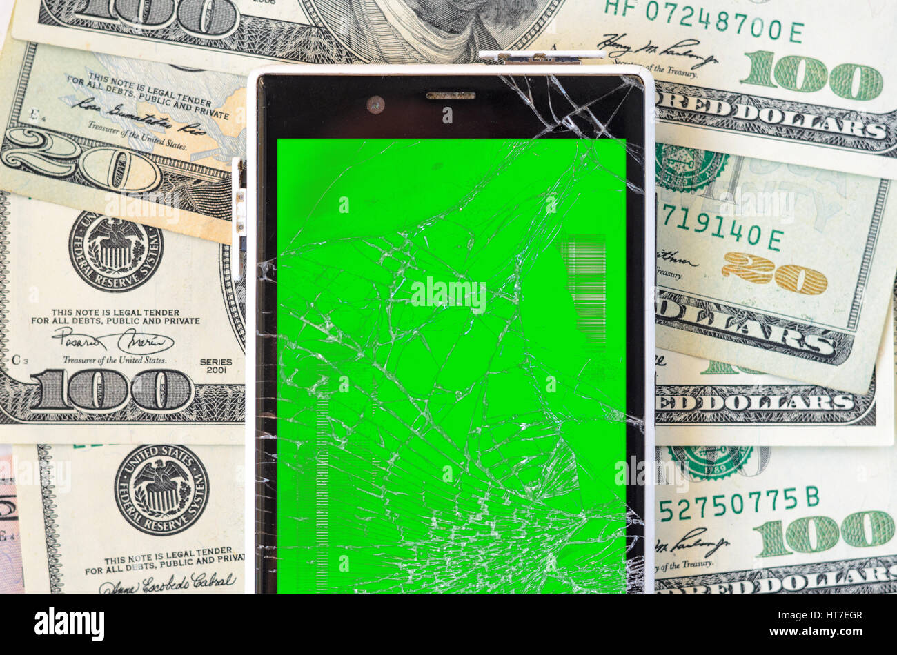 White Broken Smartphone on money banknotes background. Green chroma key ...