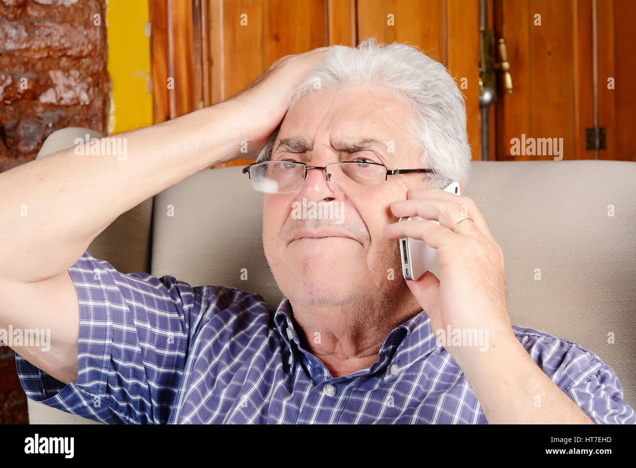 Portrait of an old man talking on the phone. Indoors Stock Photo - Alamy