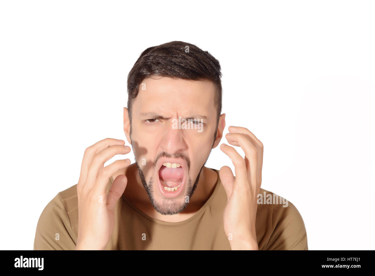Portrait of a young man with angry expression. Isolated white ...