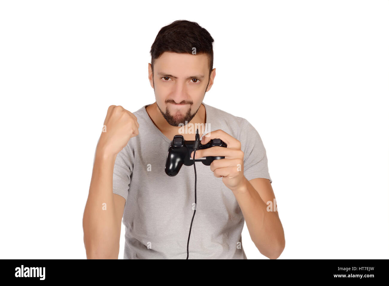 Portrait of young man playing videogames. Isolated white background ...