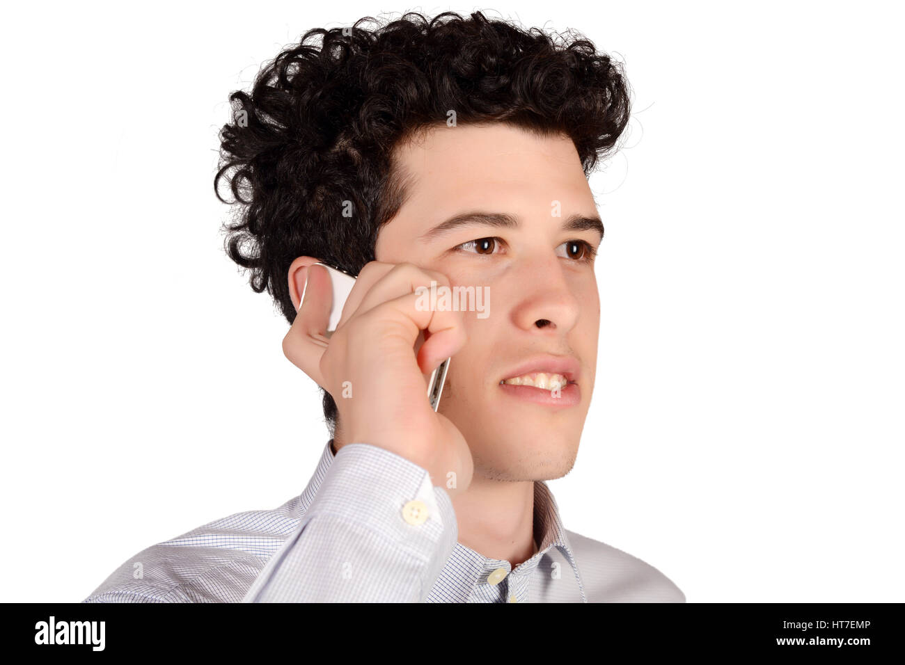 Portrait of a young handsome man talking on the phone. Isolated white ...